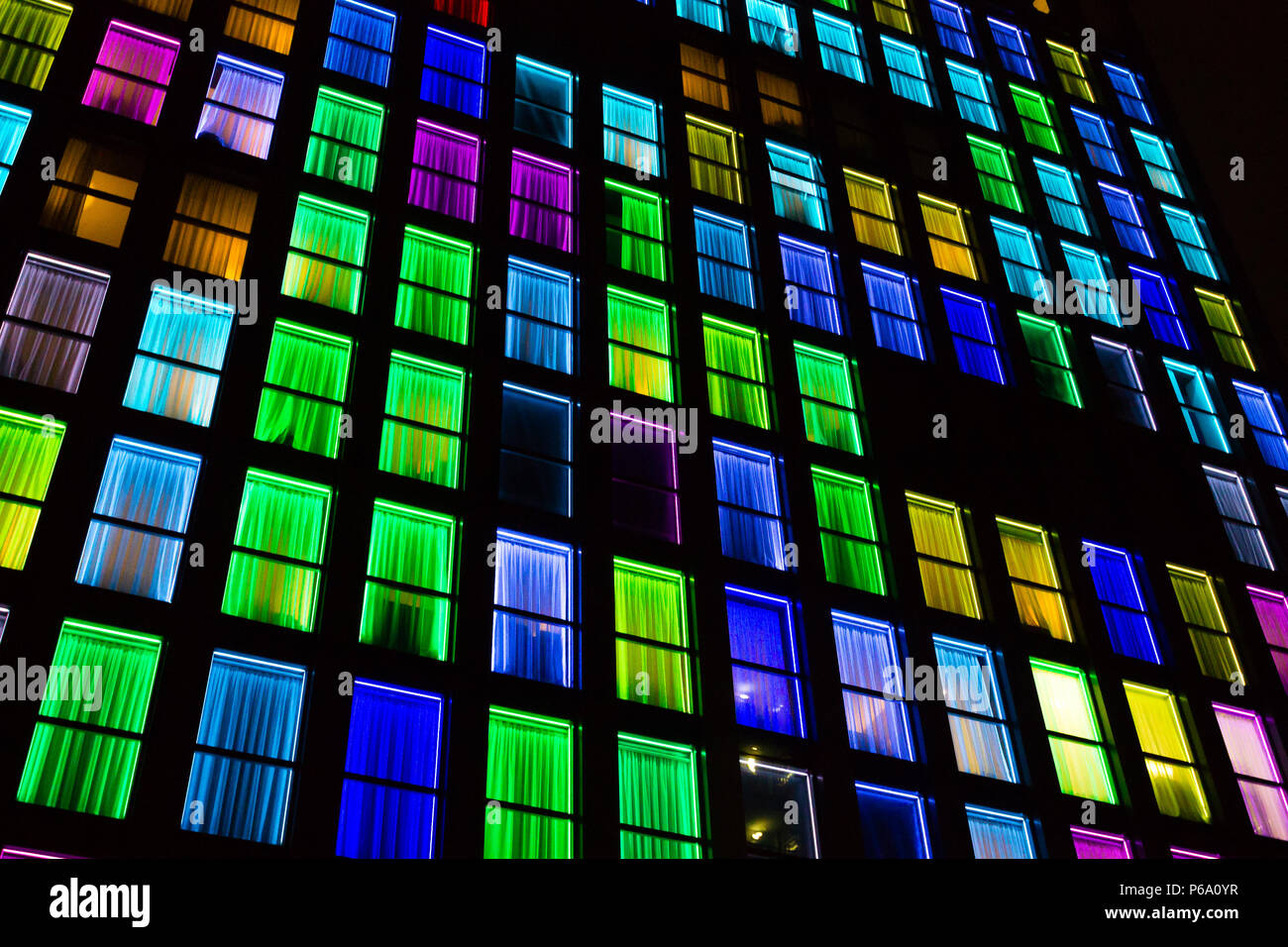 Colored windows texture. Windows illuminated by neon lights background ...