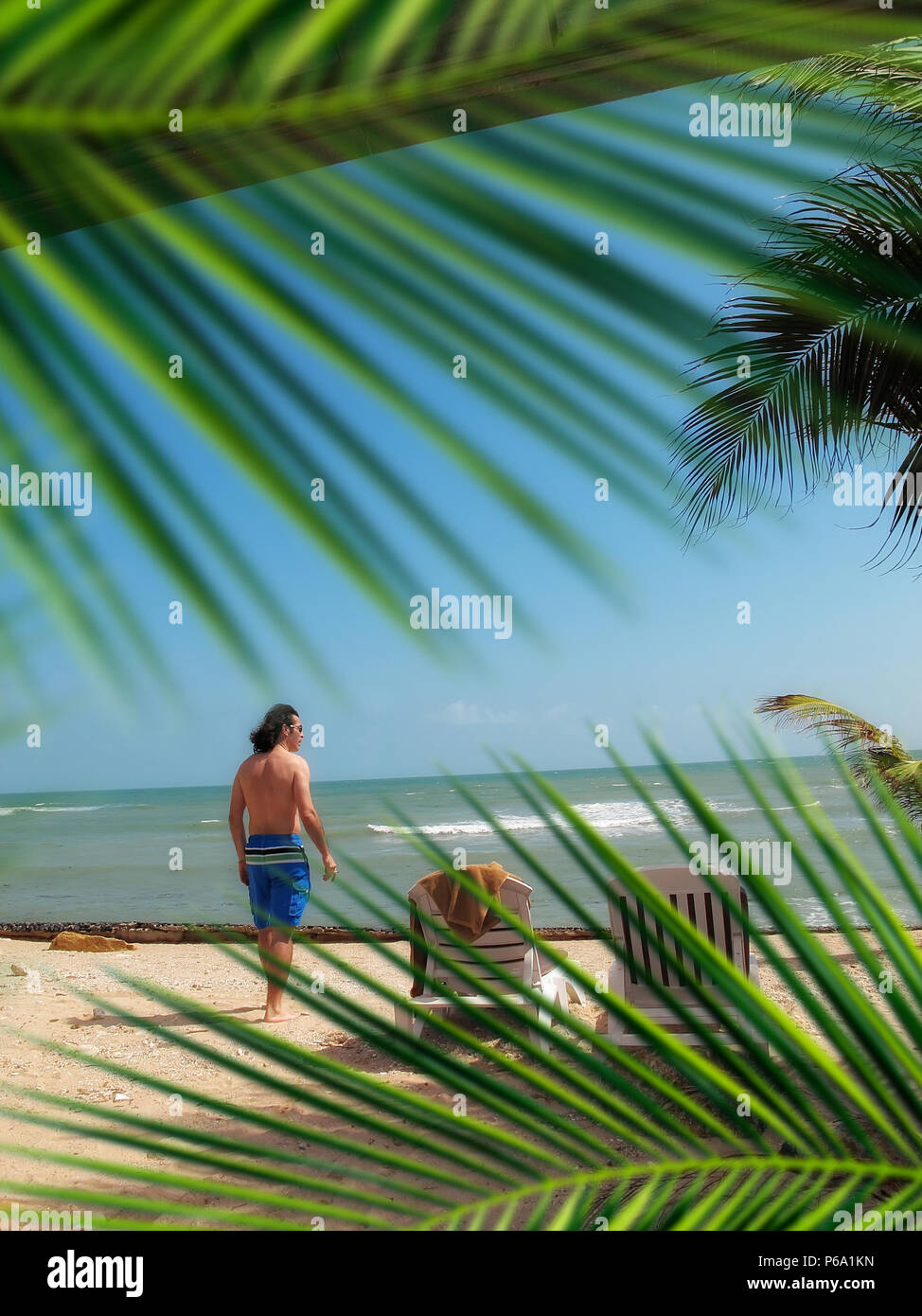 young adult man relaxing on beach Stock Photo - Alamy