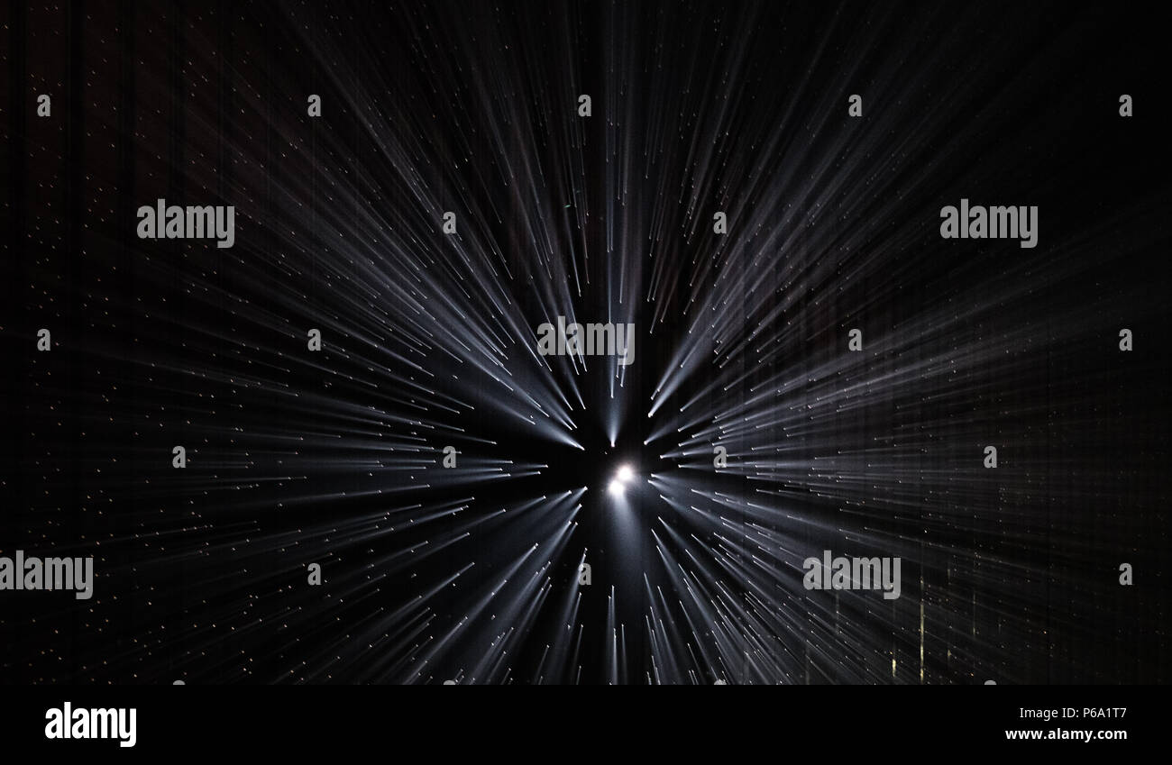 Light rays through small holes in a dark metal space Stock Photo - Alamy
