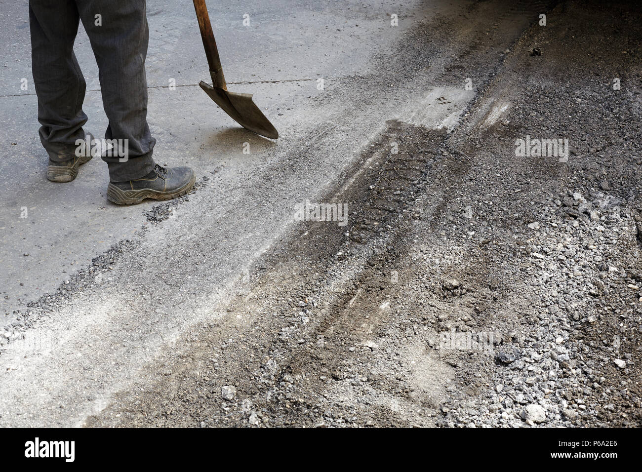 Worker using asphalt paver tool during road construction Stock Photo ...
