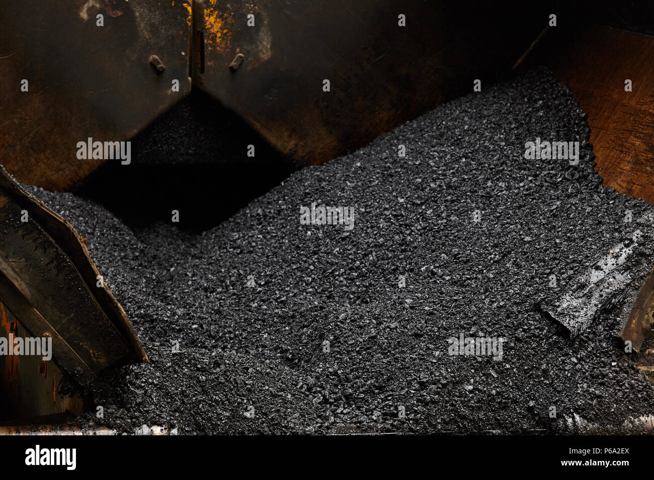 Industrial pavement machine laying fresh asphalt on road construction ...