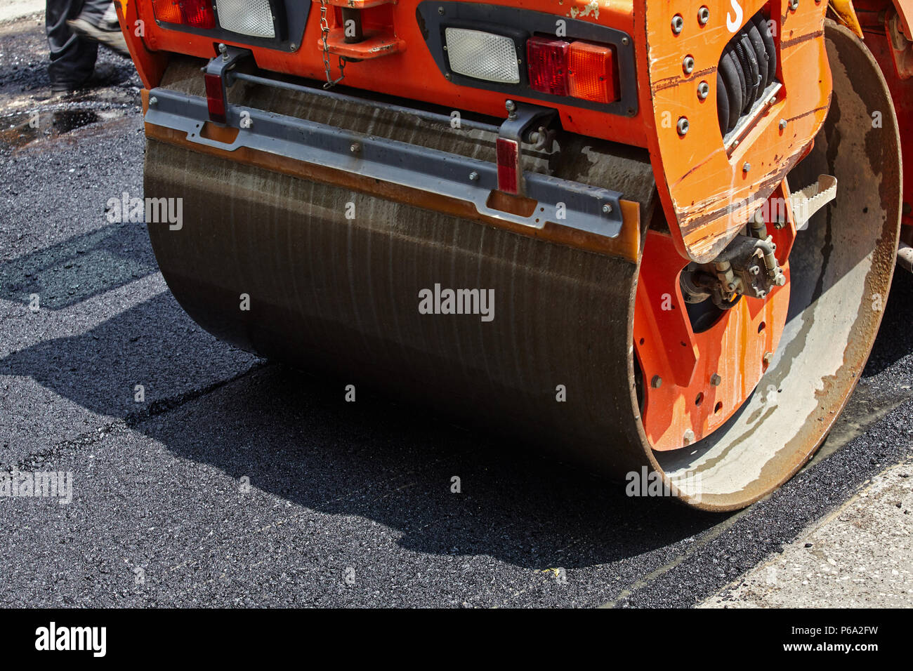 Roller machine working on the asphalt road construction Stock Photo - Alamy