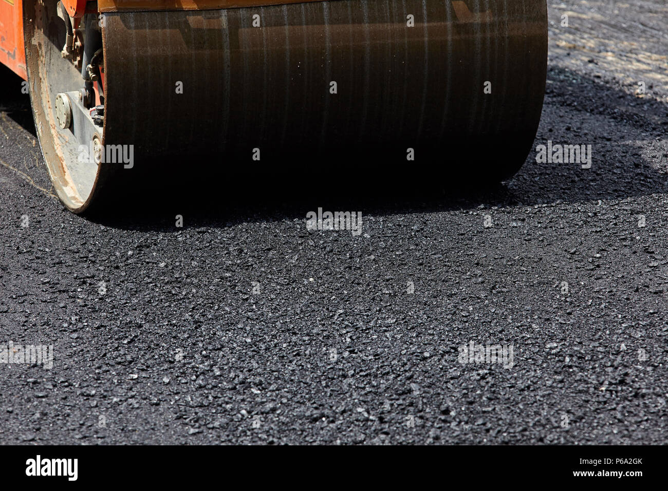 Roller machine working on the asphalt road construction Stock Photo - Alamy