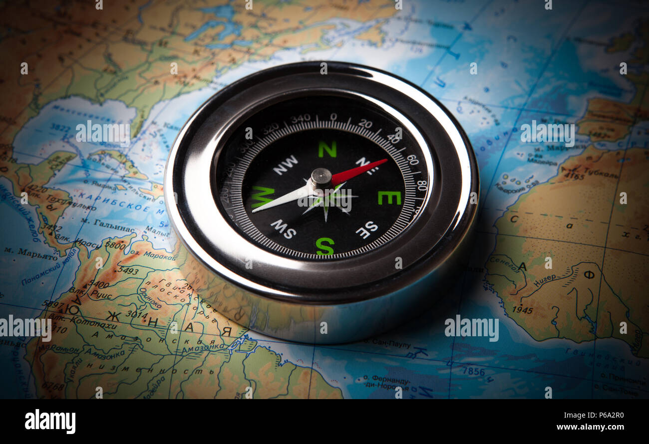 tourist compass lying on a map closeup Stock Photo - Alamy