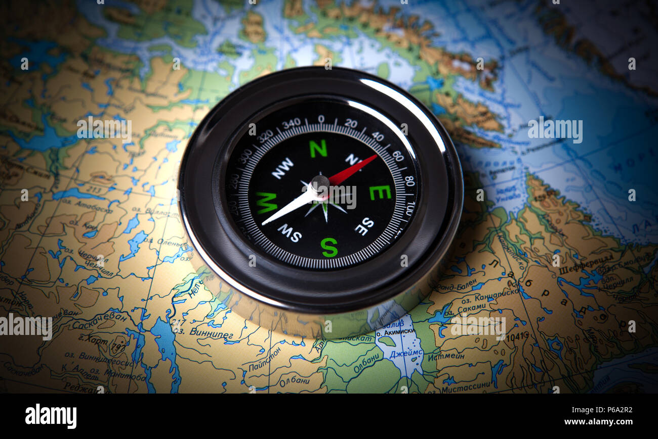 tourist compass lying on a map closeup Stock Photo - Alamy
