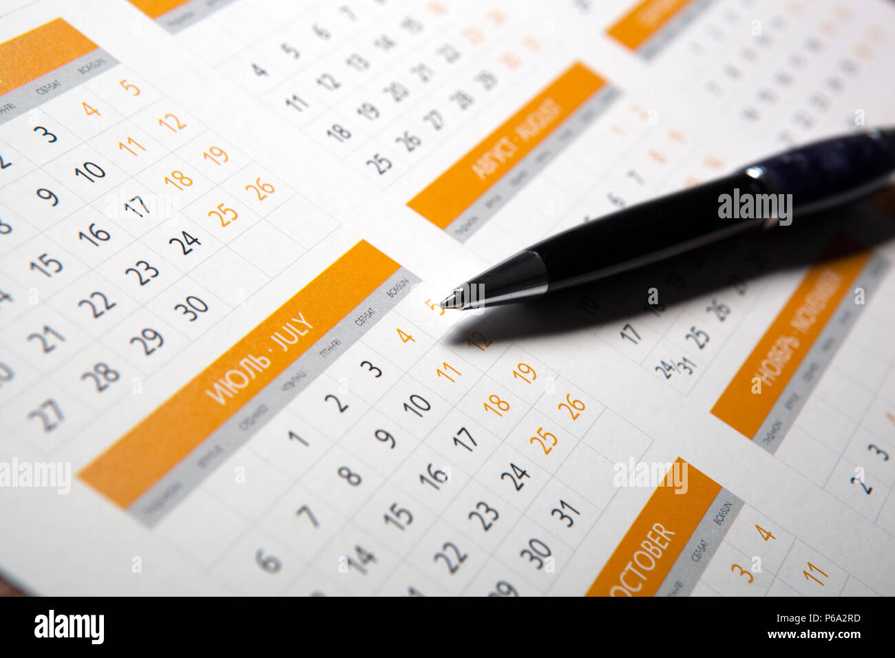 wall calendar with pen closeup and macro Stock Photo - Alamy
