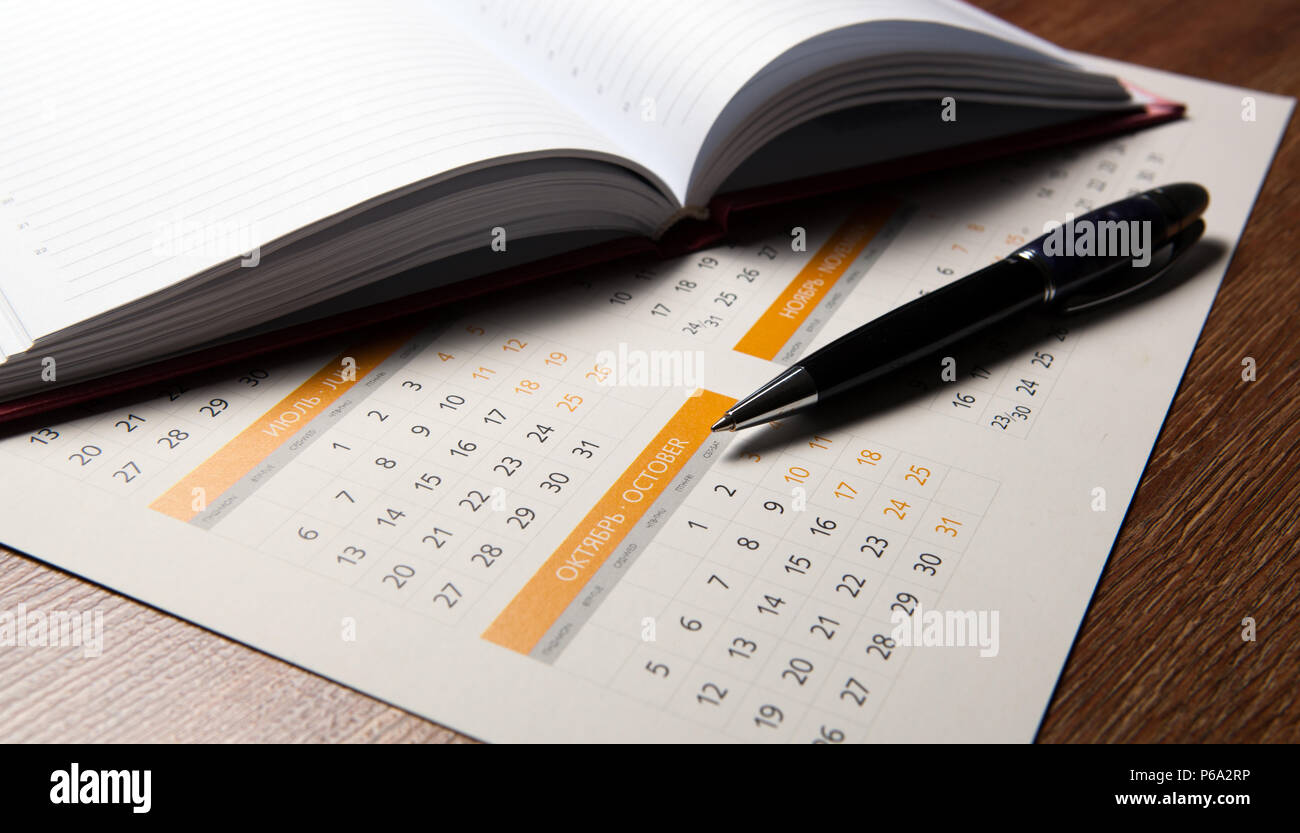 wall calendar with pen and business diary closeup Stock Photo - Alamy