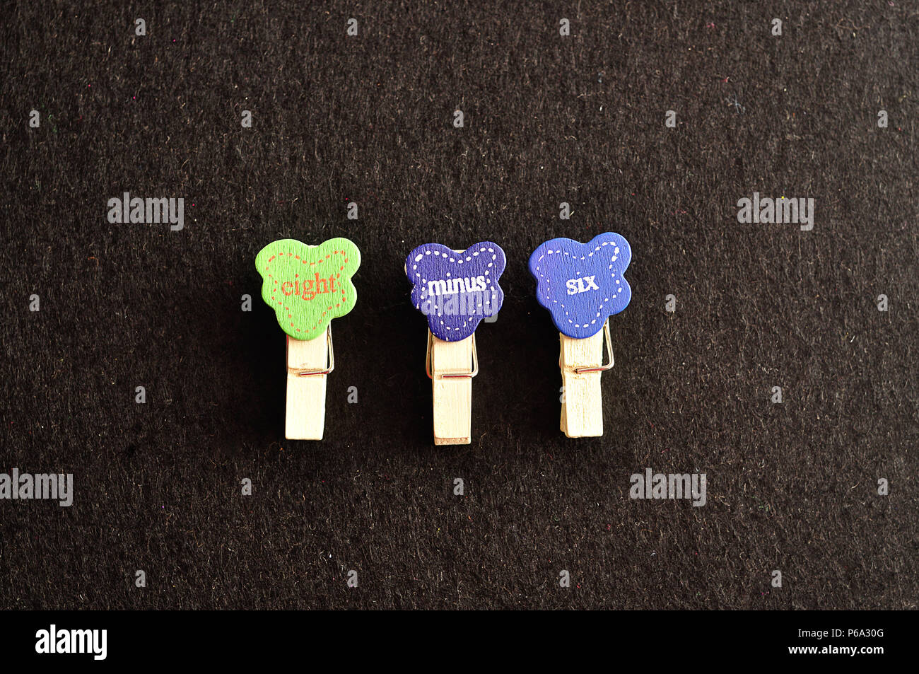 Eight minus six on a black background Stock Photo - Alamy