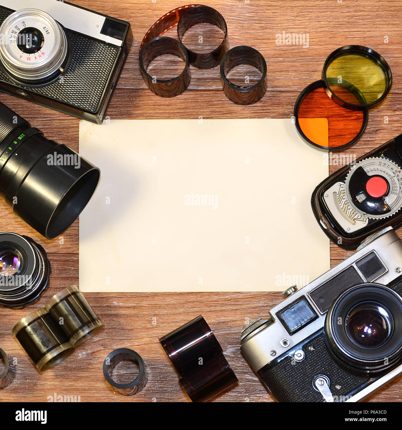 Retro camera and some old photos on wooden table. Vintage mock up for ...