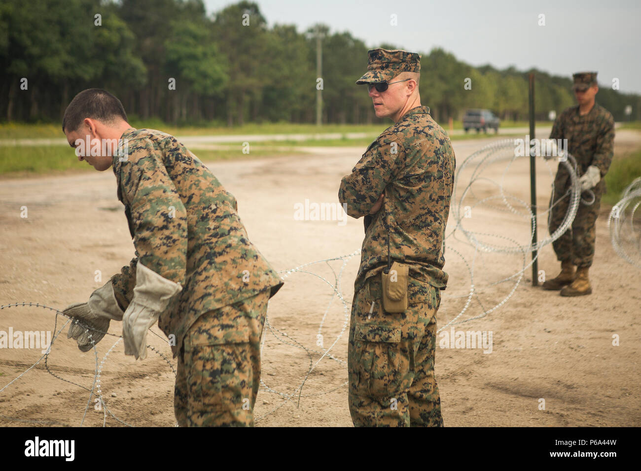 U.S. Marine Corps 1st Lt. Matthew Himes, center, assistant operations ...
