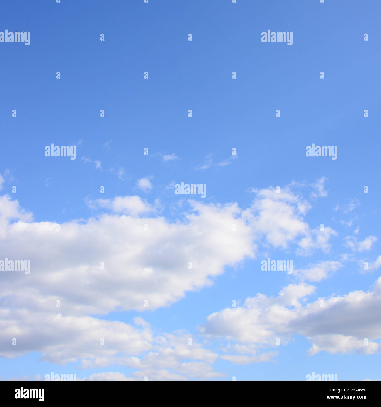 A blue sky with lots of white clouds of different sizes Stock Photo - Alamy