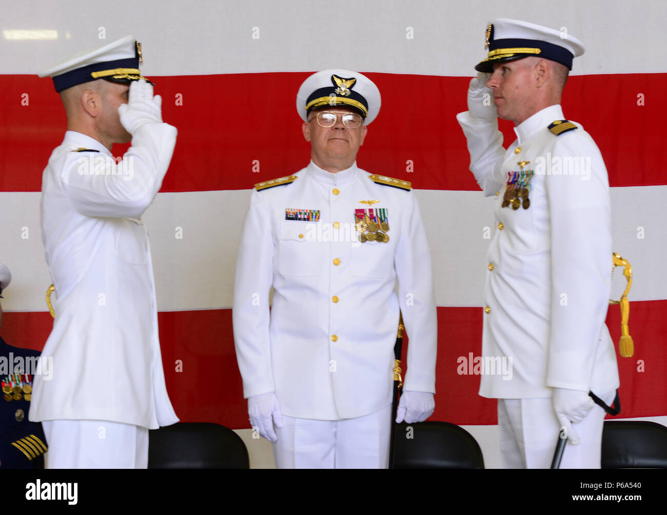 Capt. Daniel Travers returns a salute to Capt. William Timmons, while ...