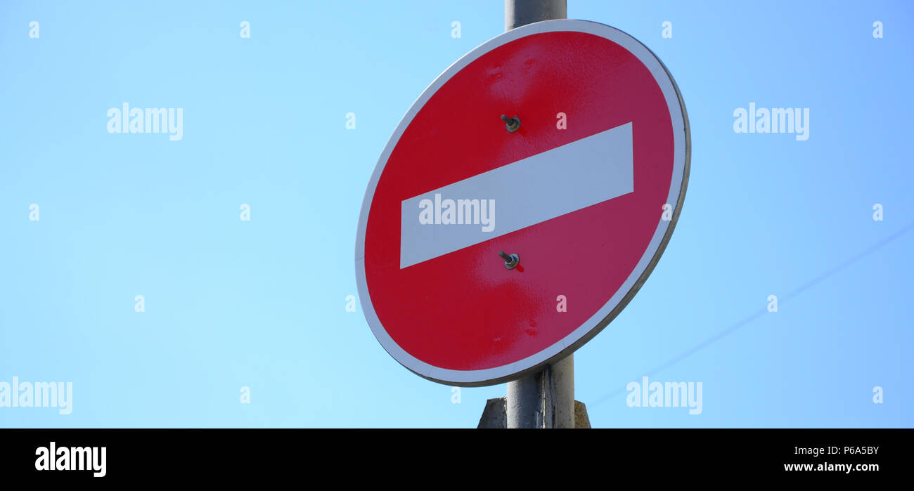 Road sign in the form of a white rectangle in a red circle. No entry ...