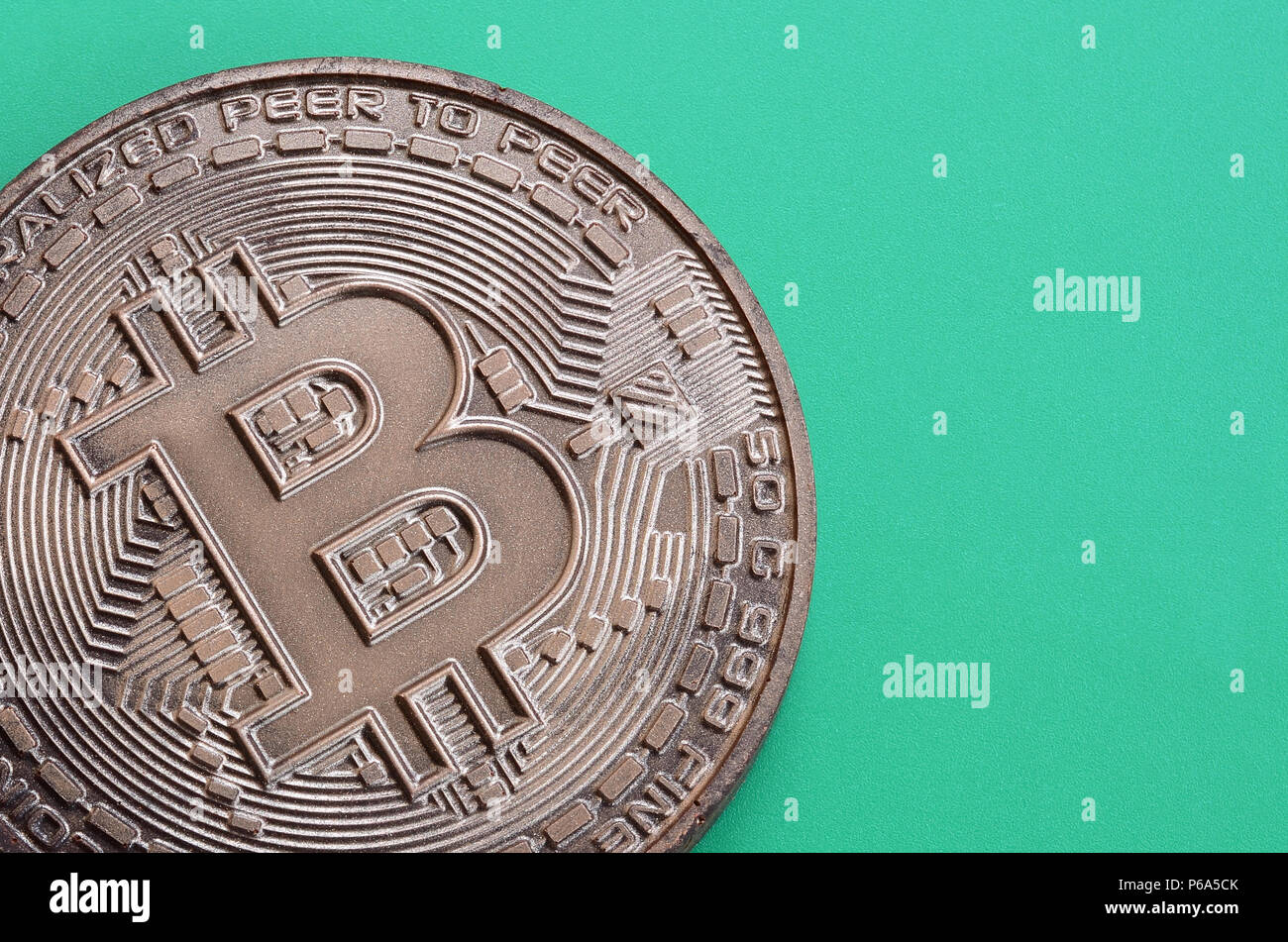Chocolate product in the form of physical bitcoin lies on a green ...