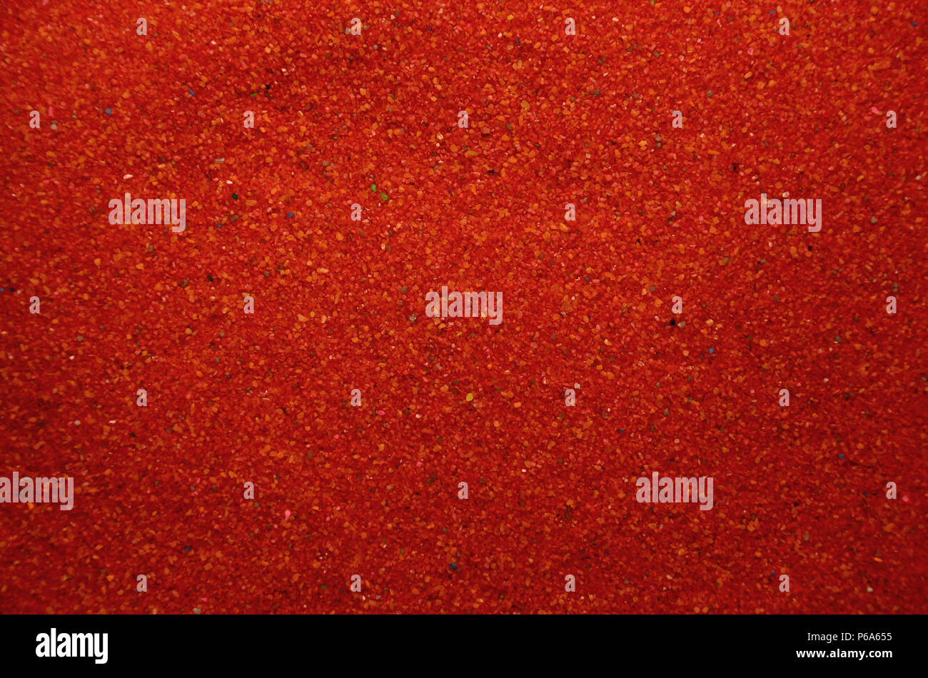 Texture of a colored granular sand close up. Red grains Stock Photo - Alamy