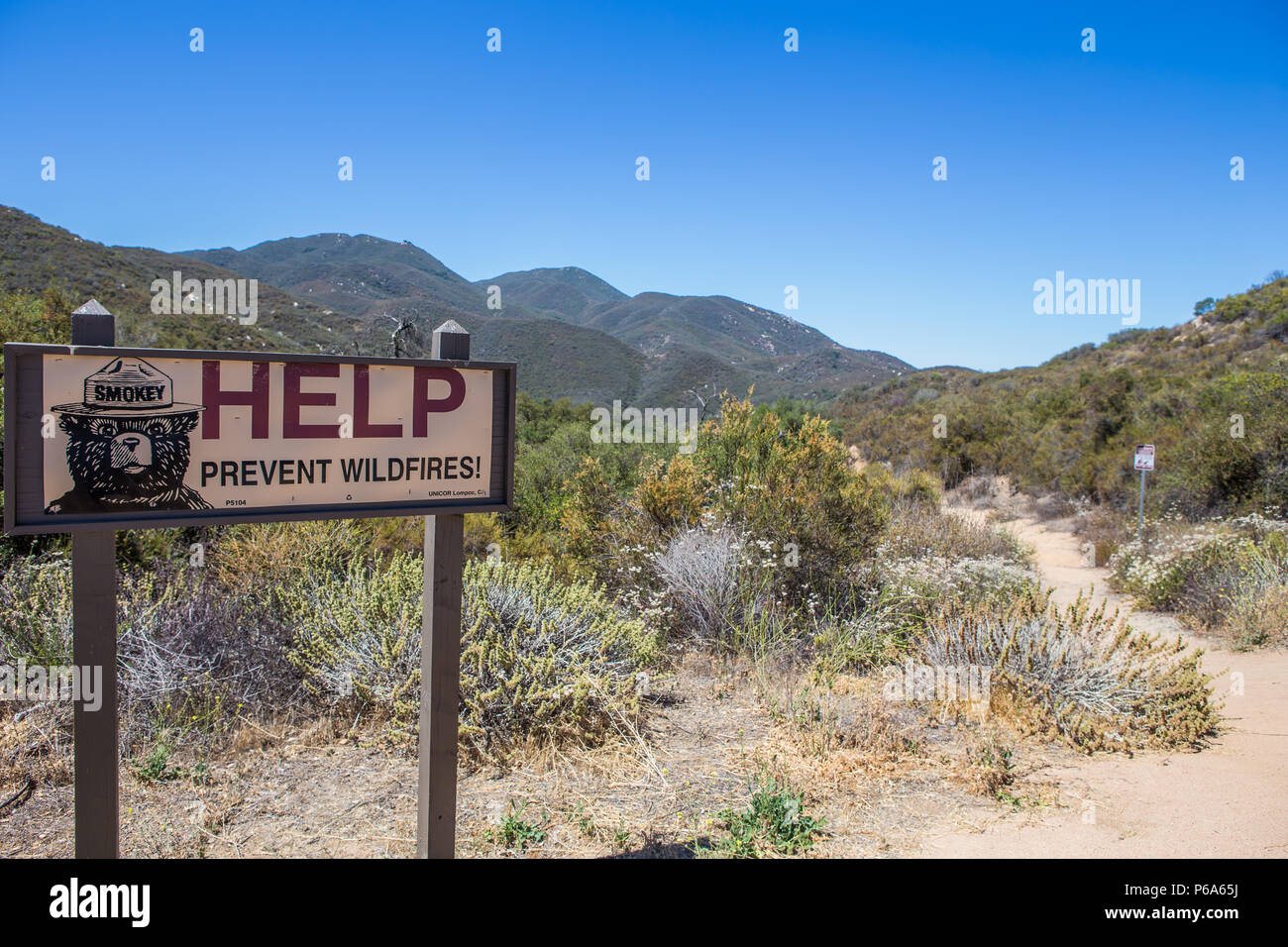 A Smokey Bear warning sign reading Help prevent wildfires in the ...
