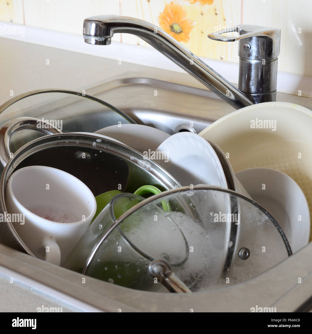 Dirty dishes and unwashed kitchen appliances filled the kitchen sink ...