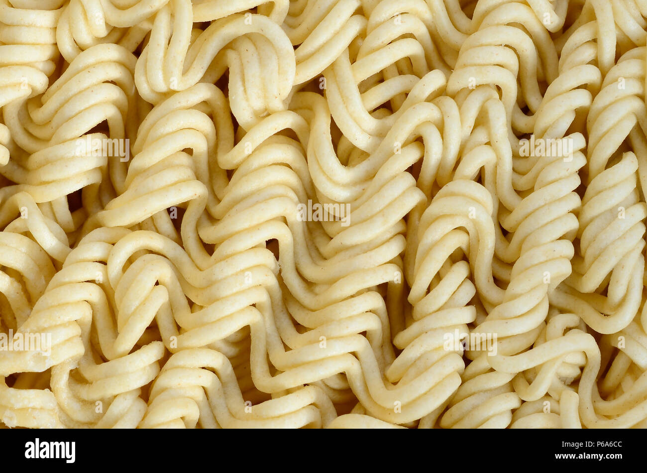 Close up view of yellow dry instant noodles. Chinese traditional food ...