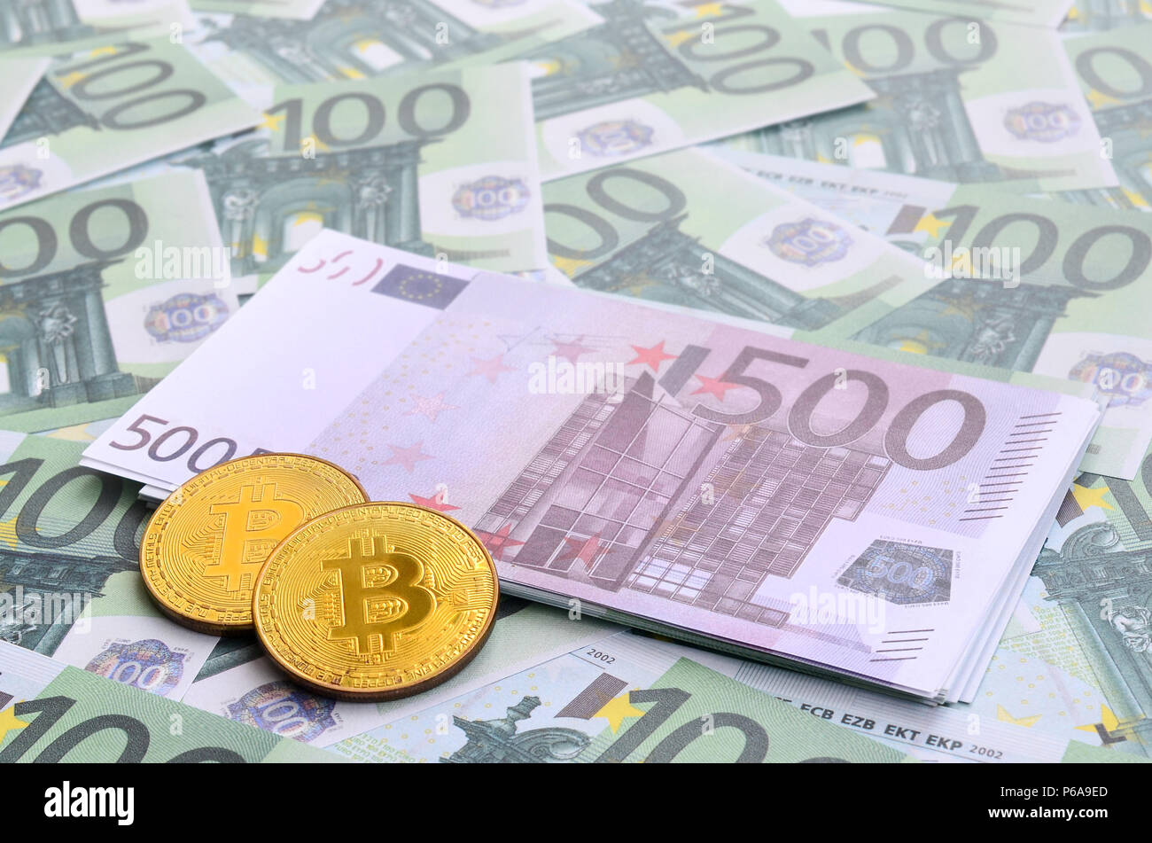 Golden physical bitcoins is lies on a set of green monetary ...