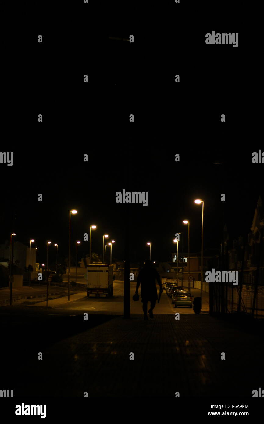 Nocturnes - Strangers- Silhouette of a male figure walking along dark ...