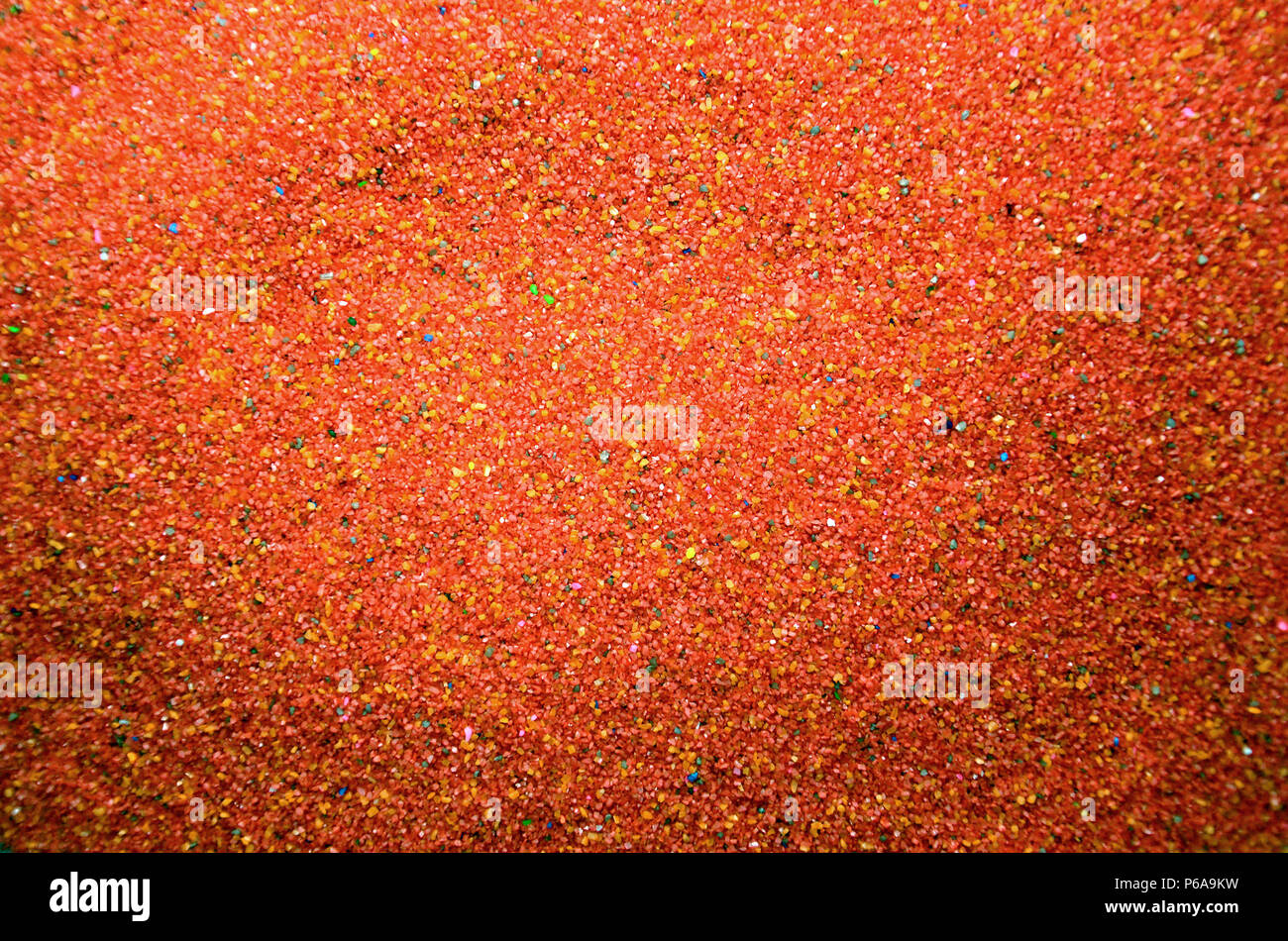 Texture of a colored granular sand close up. Red grains Stock Photo - Alamy