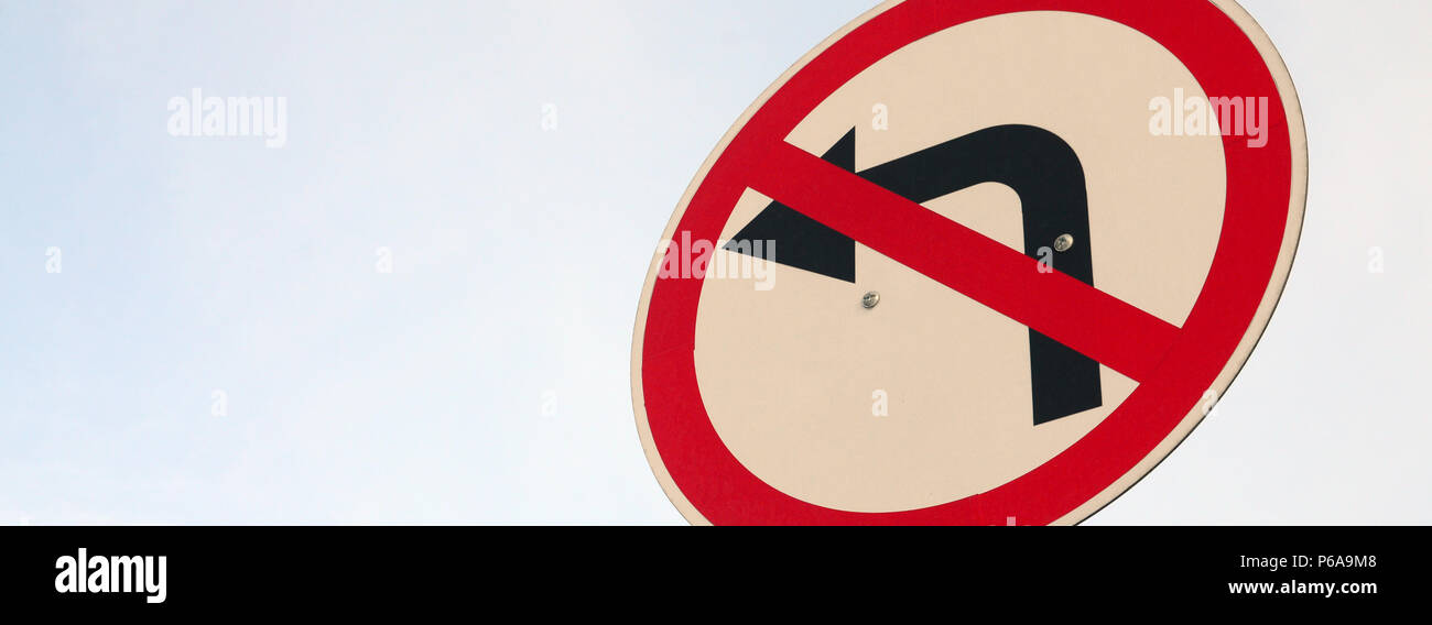 Turn left is prohibited. Traffic sign with crossed out arrow to the ...