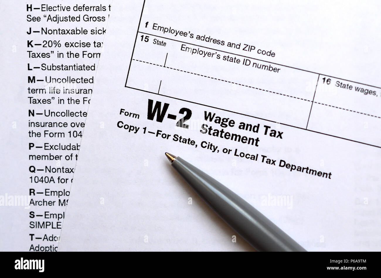 The pen lies on the tax form W-2 Wage and Tax Statement. The time to pay taxes Stock Photo - Alamy