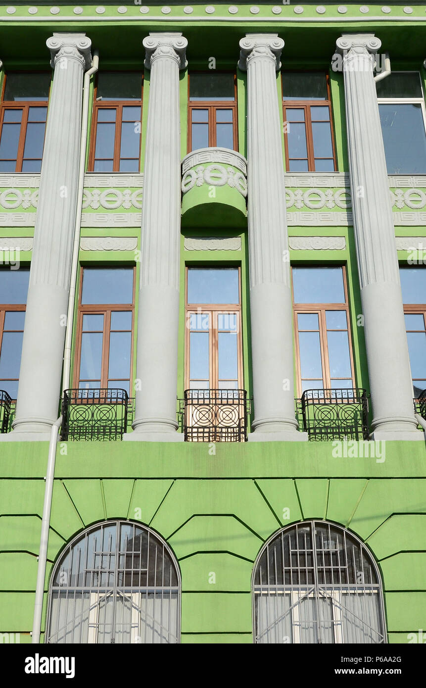 Restored old multi-storey building with antique columns, painted in ...