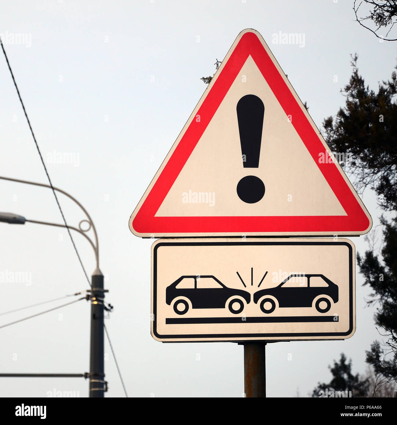 High risk of collision. A road sign with an exclamation point and two ...