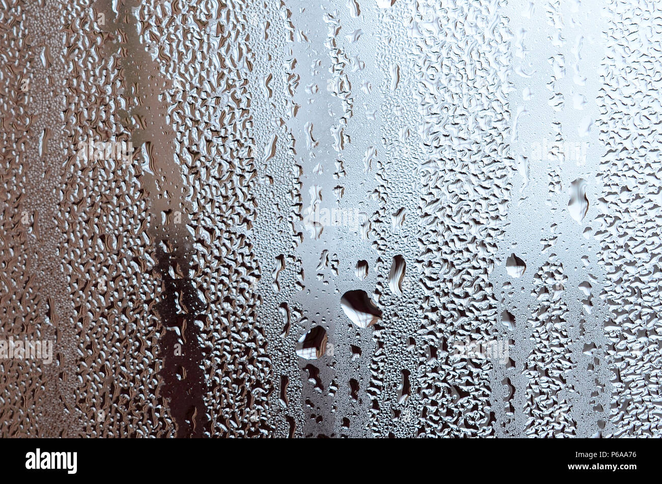 Texture of a drop of rain on a glass wet transparent background. Toned ...
