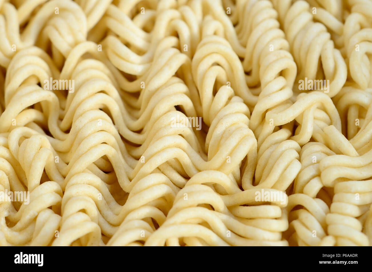 Close up view of yellow dry instant noodles. Chinese traditional food ...