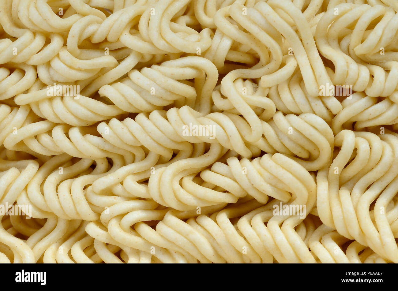 Close up view of yellow dry instant noodles. Chinese traditional food ...