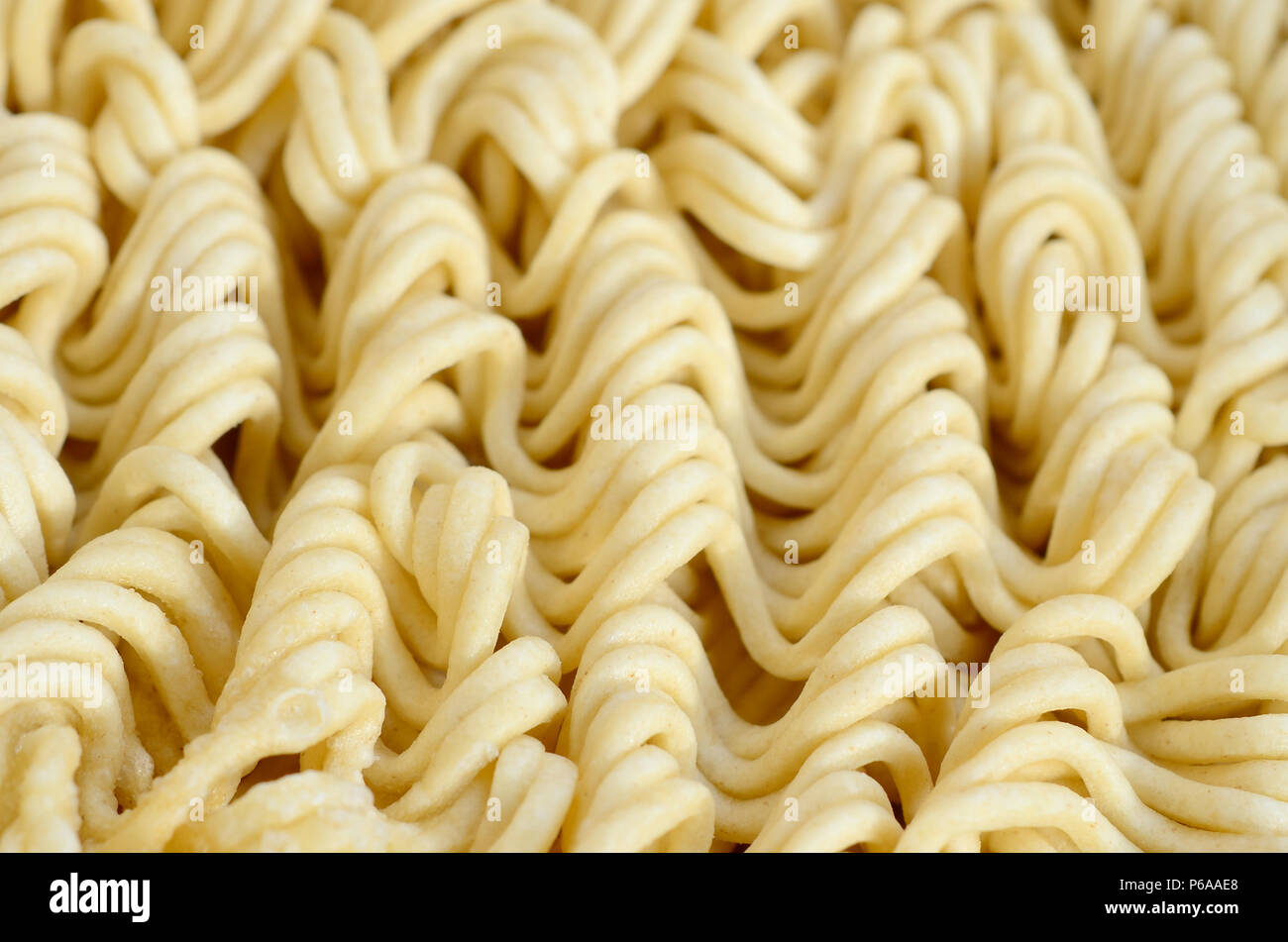 Close up view of yellow dry instant noodles. Chinese traditional food ...