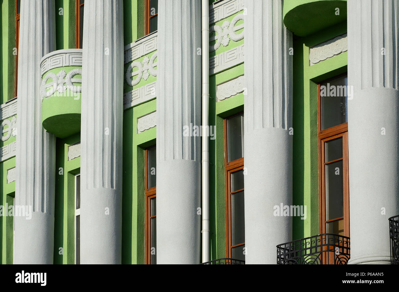Restored old multi-storey building with antique columns, painted in ...