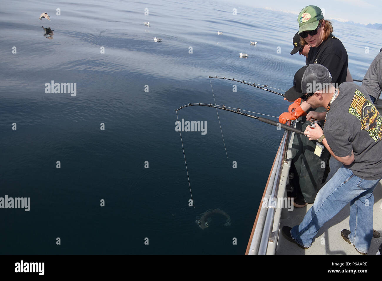 A volunteer deck hand instructed a military angler on landing a spiny ...