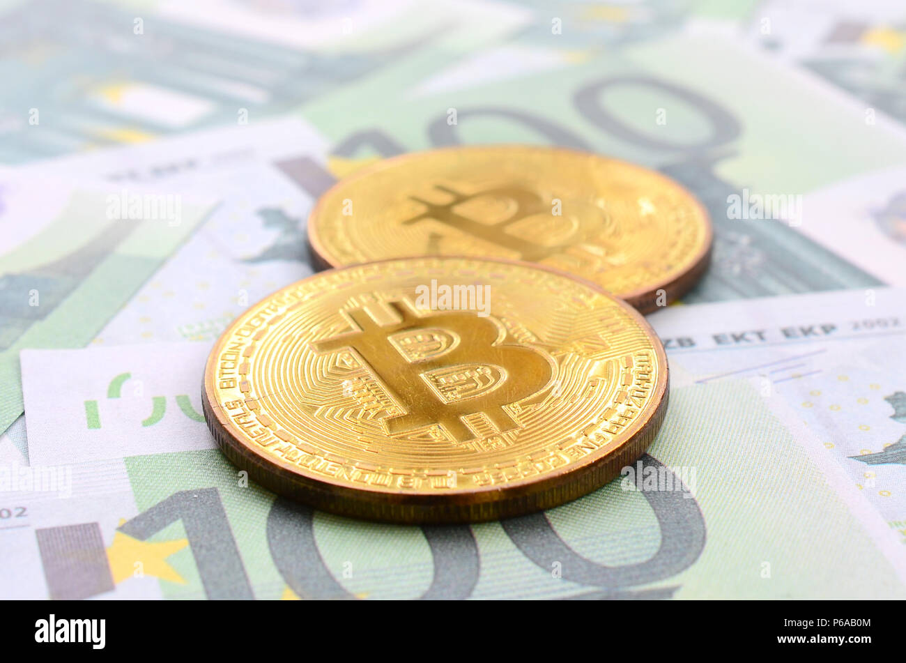 Golden physical bitcoins is lies on a set of green monetary ...
