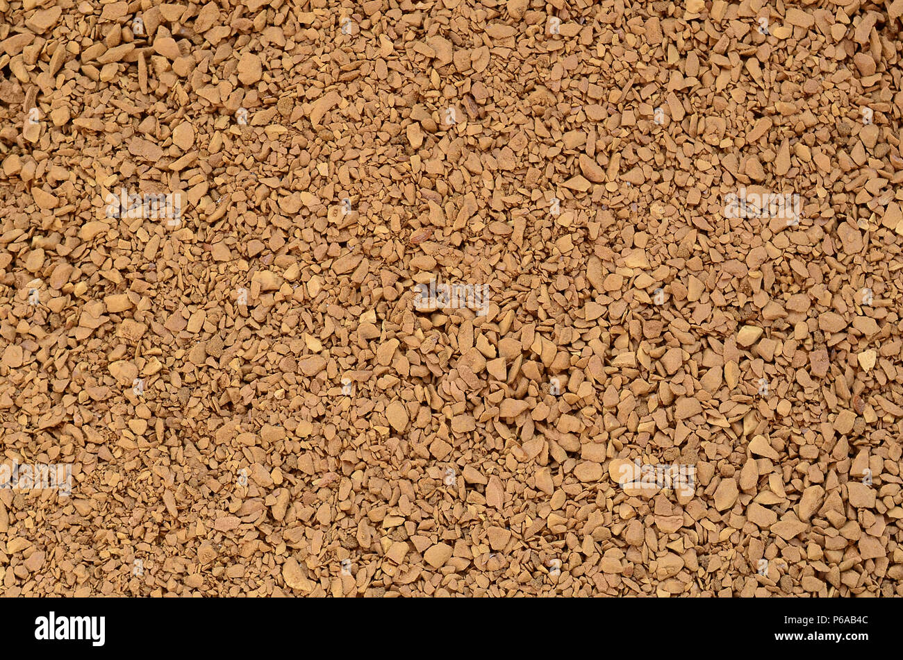Texture of ground coffee in the form of many small pebbles of dark ...