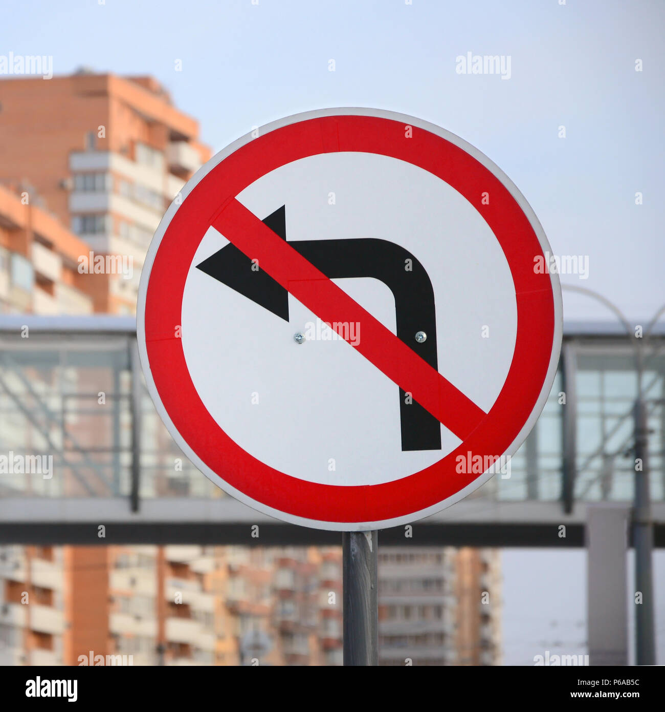 Turn left is prohibited. Traffic sign with crossed out arrow to the ...