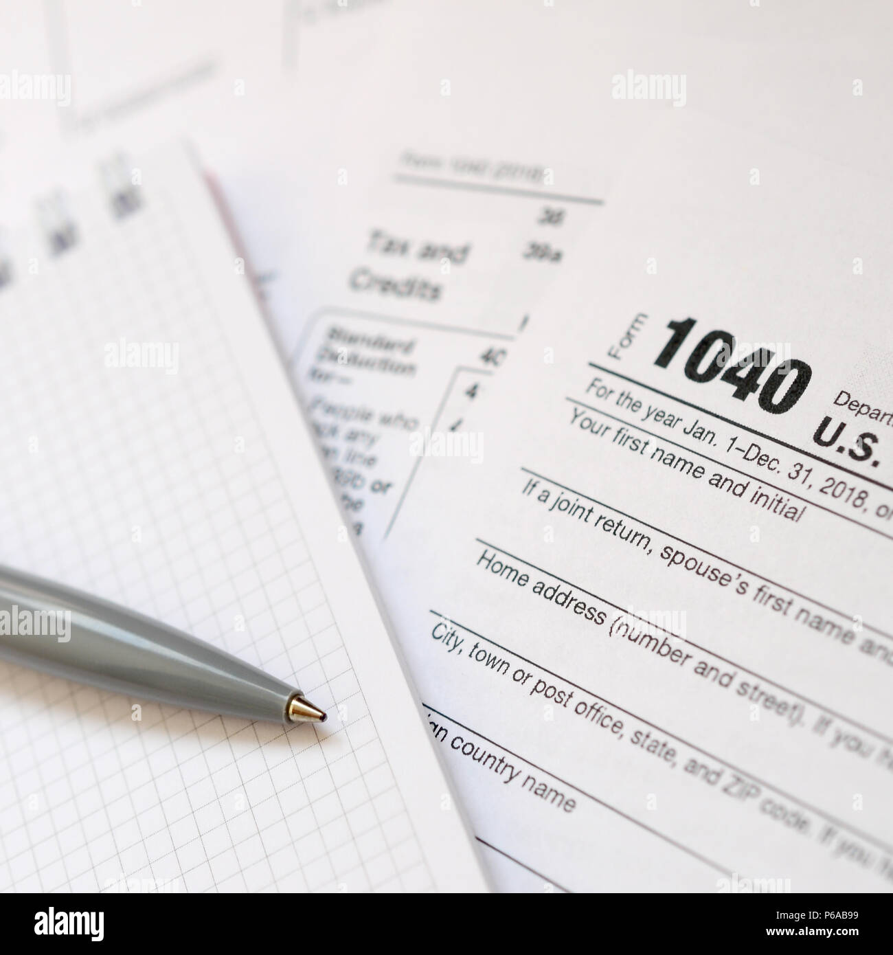 The pen and notebook is lies on the tax form 1040 U.S. Individual ...
