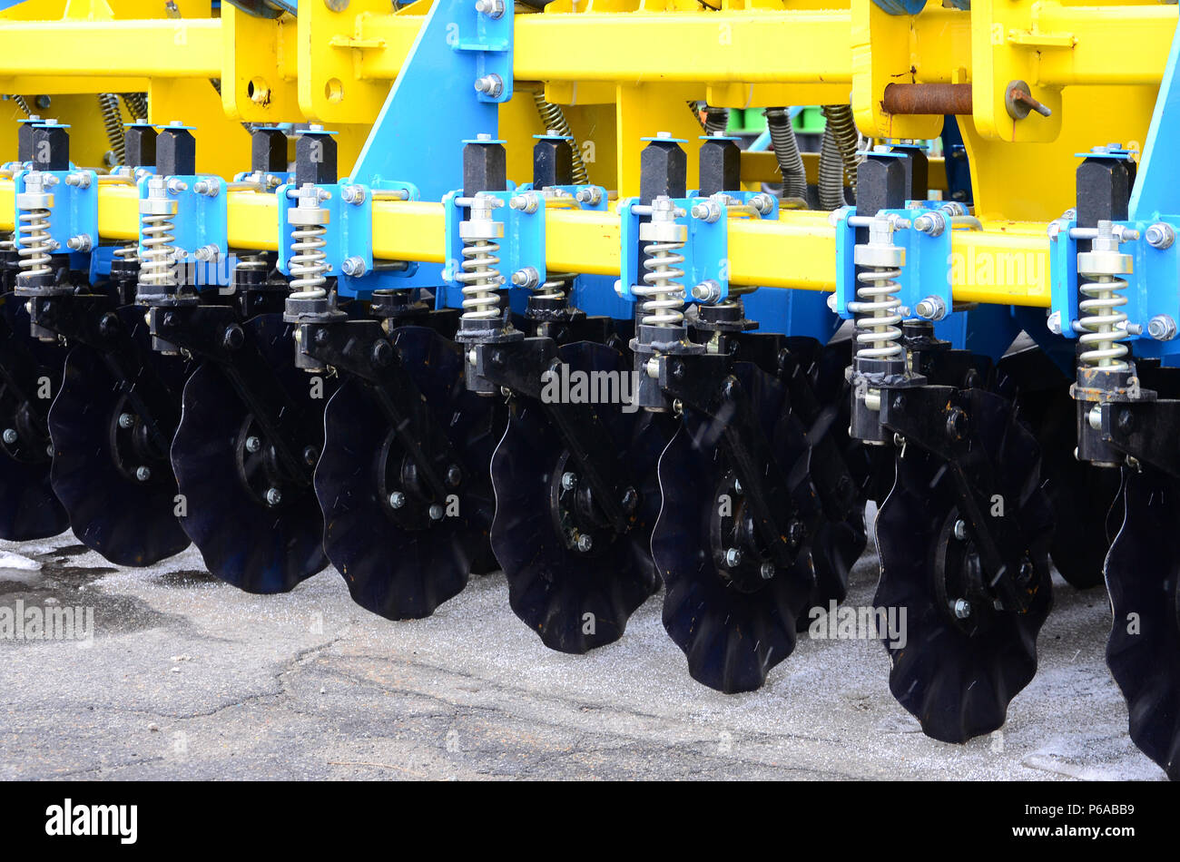 Spring system of agricultural seeder close up Stock Photo - Alamy