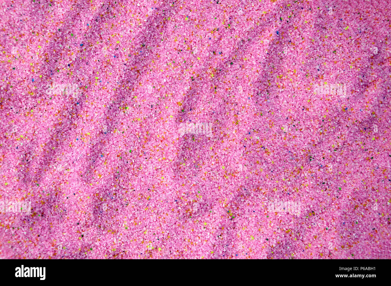 Texture of a colored granular sand close up. Pink grains Stock Photo ...