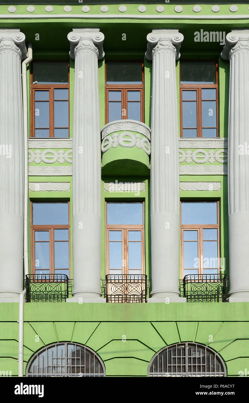 Restored old multi-storey building with antique columns, painted in ...