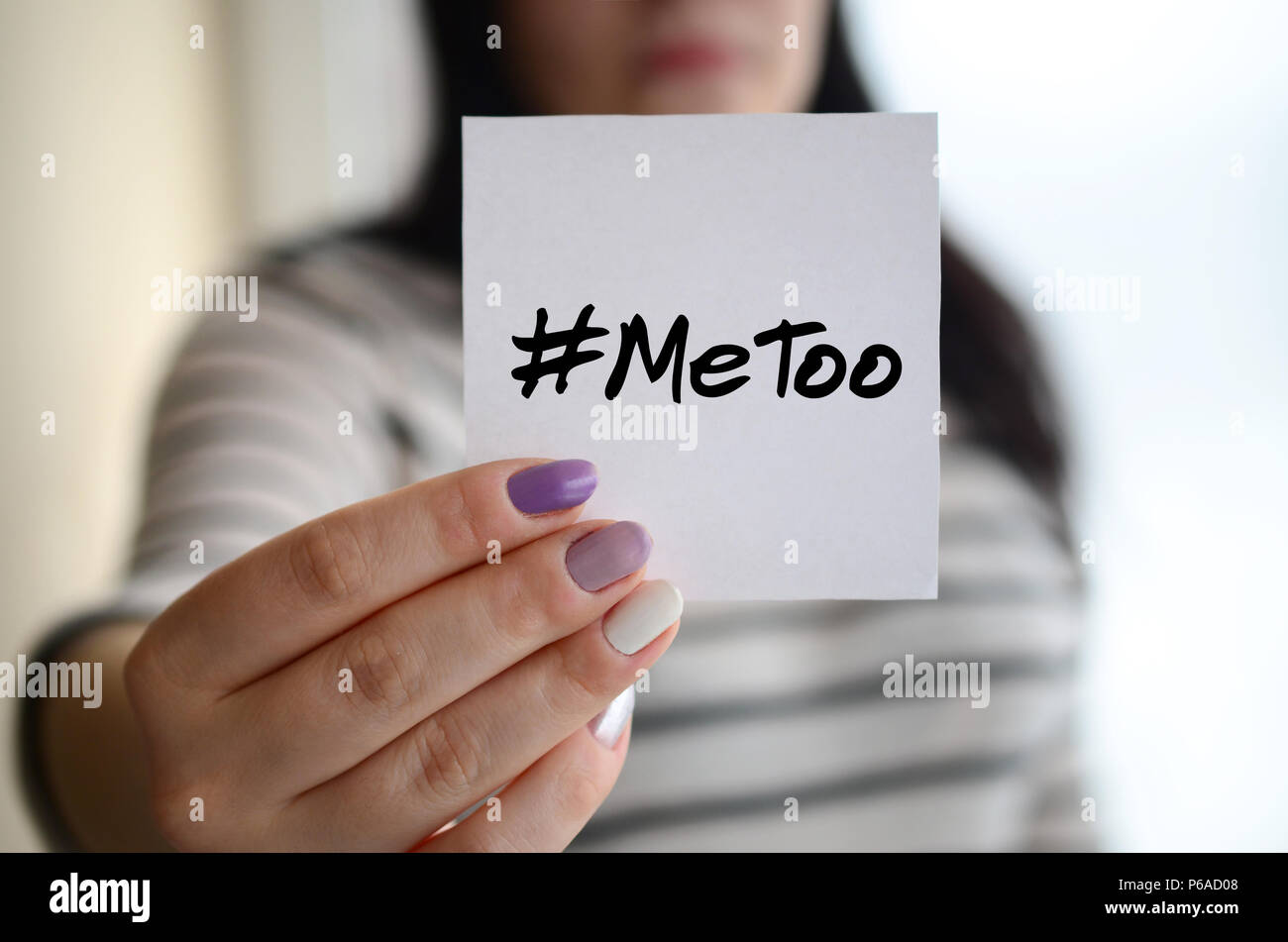 Young sad girl shows a white sticker. Caucasian brunette holding a ...