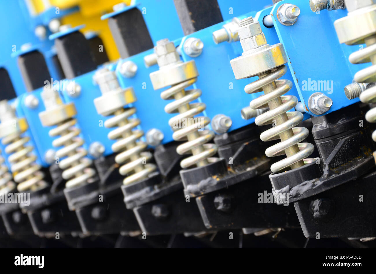 Spring system of agricultural seeder close up Stock Photo - Alamy