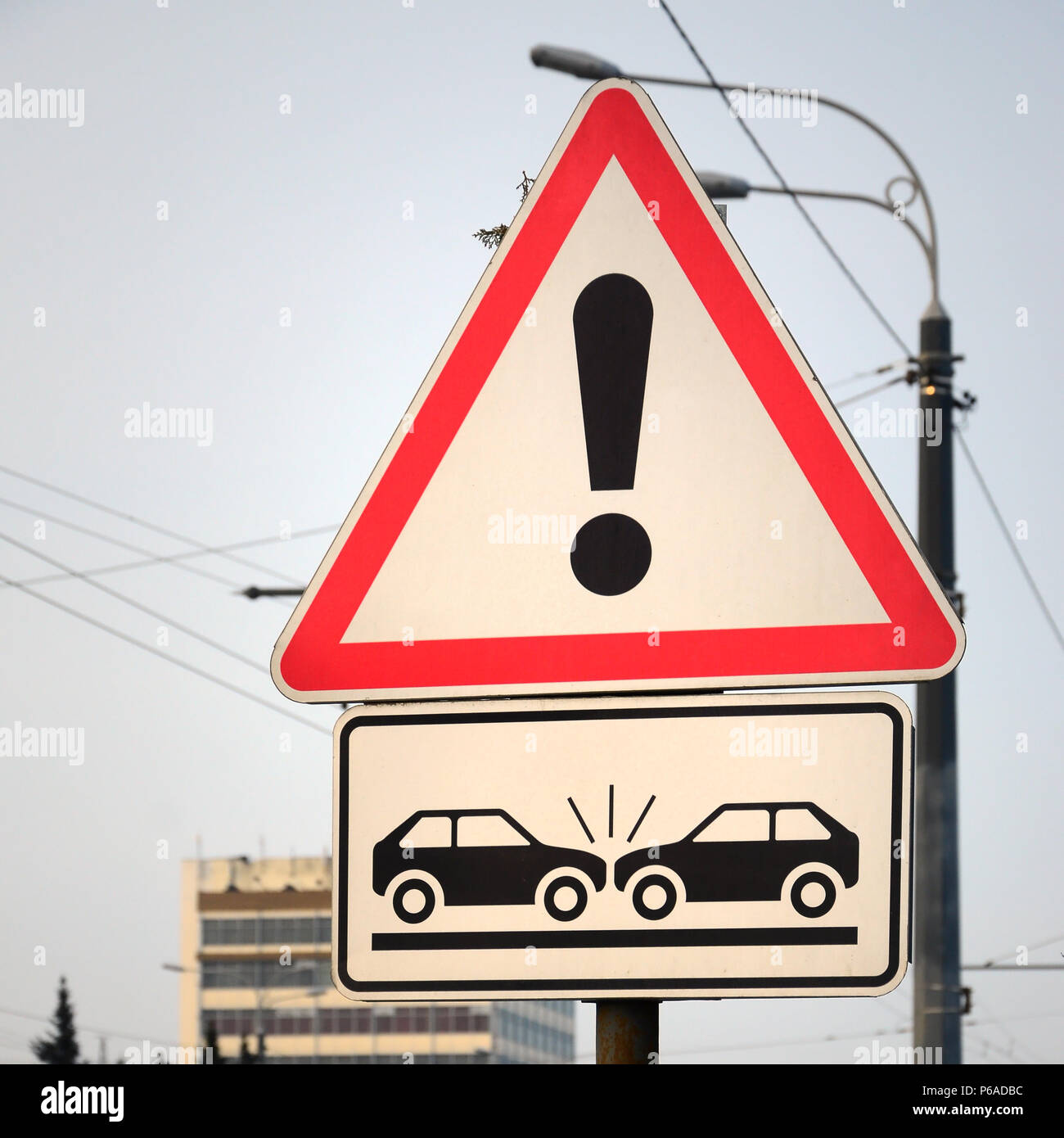 High risk of collision. A road sign with an exclamation point and two ...