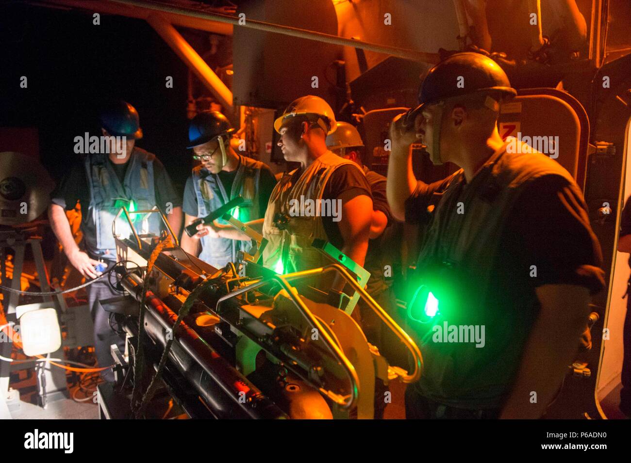 Mineman 3rd Class Kevin Lanctot, center, assigned to USS Gladiator (MCM ...
