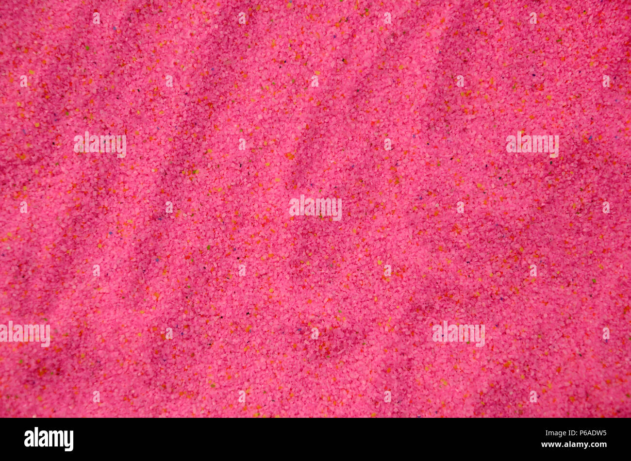 Texture of a colored granular sand close up. Pink grains Stock Photo ...