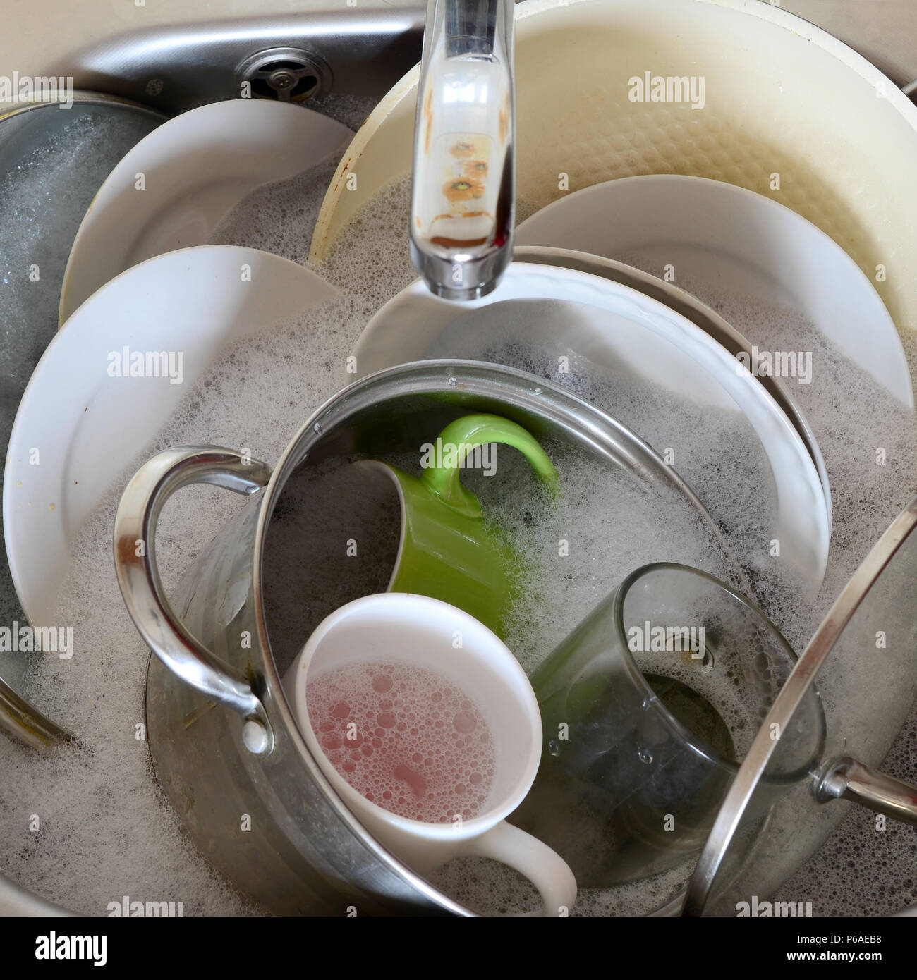 Dirty dishes and unwashed kitchen appliances filled the kitchen sink ...