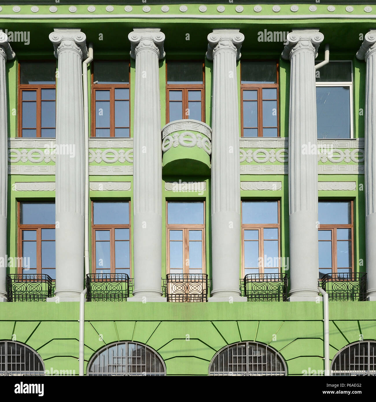 Restored old multi-storey building with antique columns, painted in ...