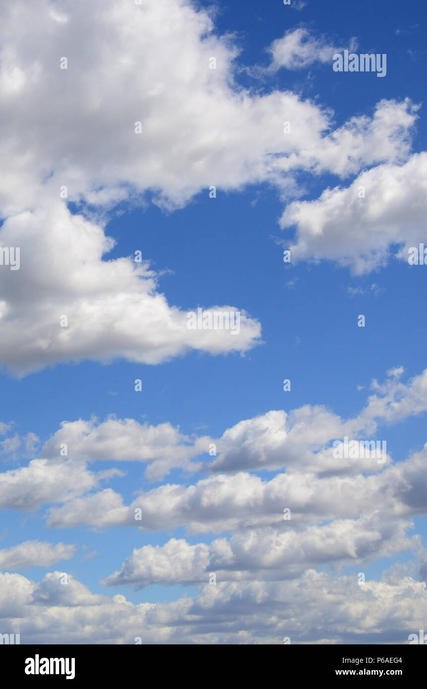 A blue sky with lots of white clouds of different sizes Stock Photo - Alamy